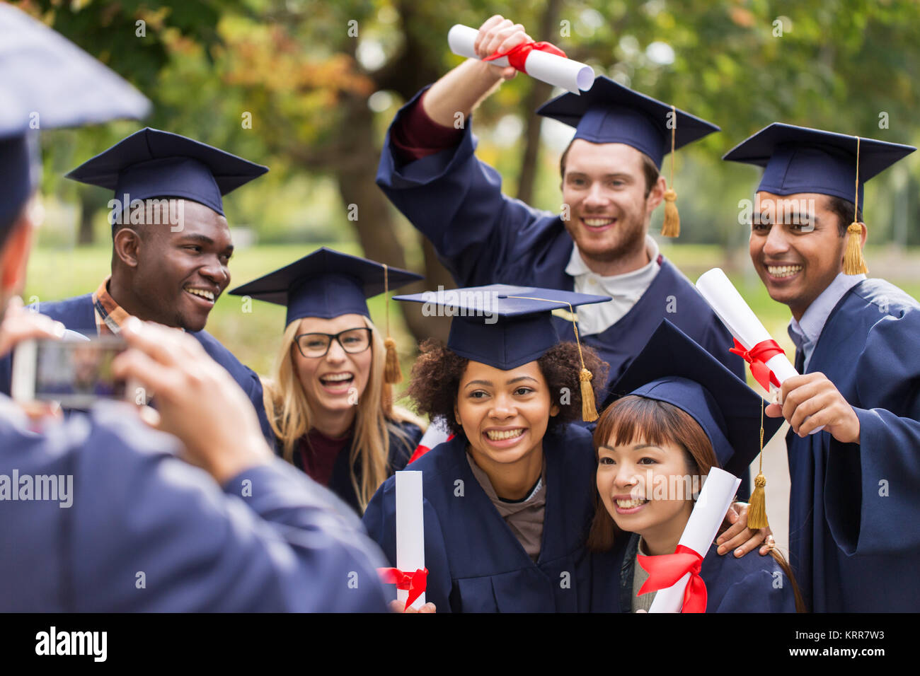 students or graduates with diplomas taking picture Stock Photo - Alamy