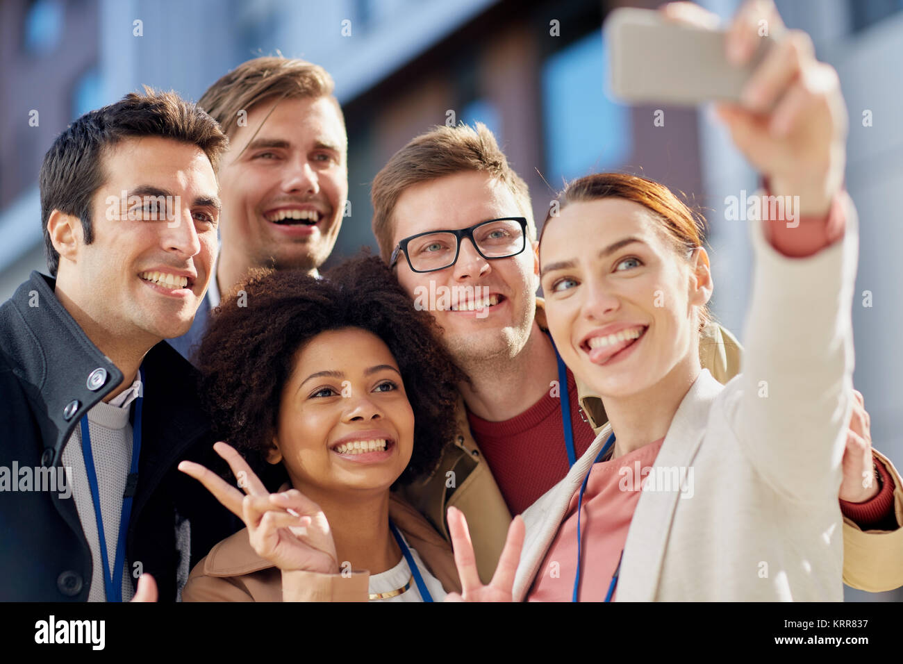 business team with conference badges taking selfie Stock Photo - Alamy