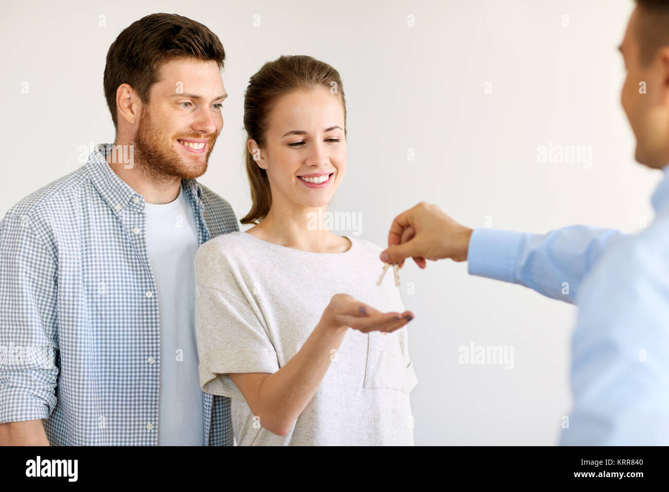 realtor giving keys from new home to happy couple Stock Photo - Alamy