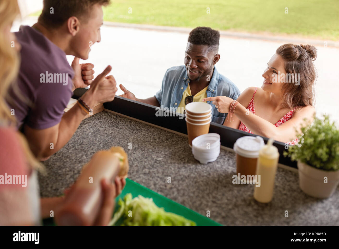 customers couple ordering something at food truck Stock Photo - Alamy