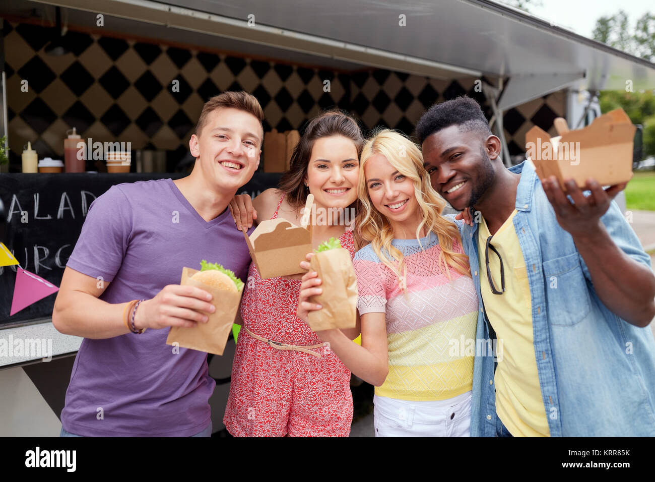 happy friends with wok and burger at food truck Stock Photo - Alamy