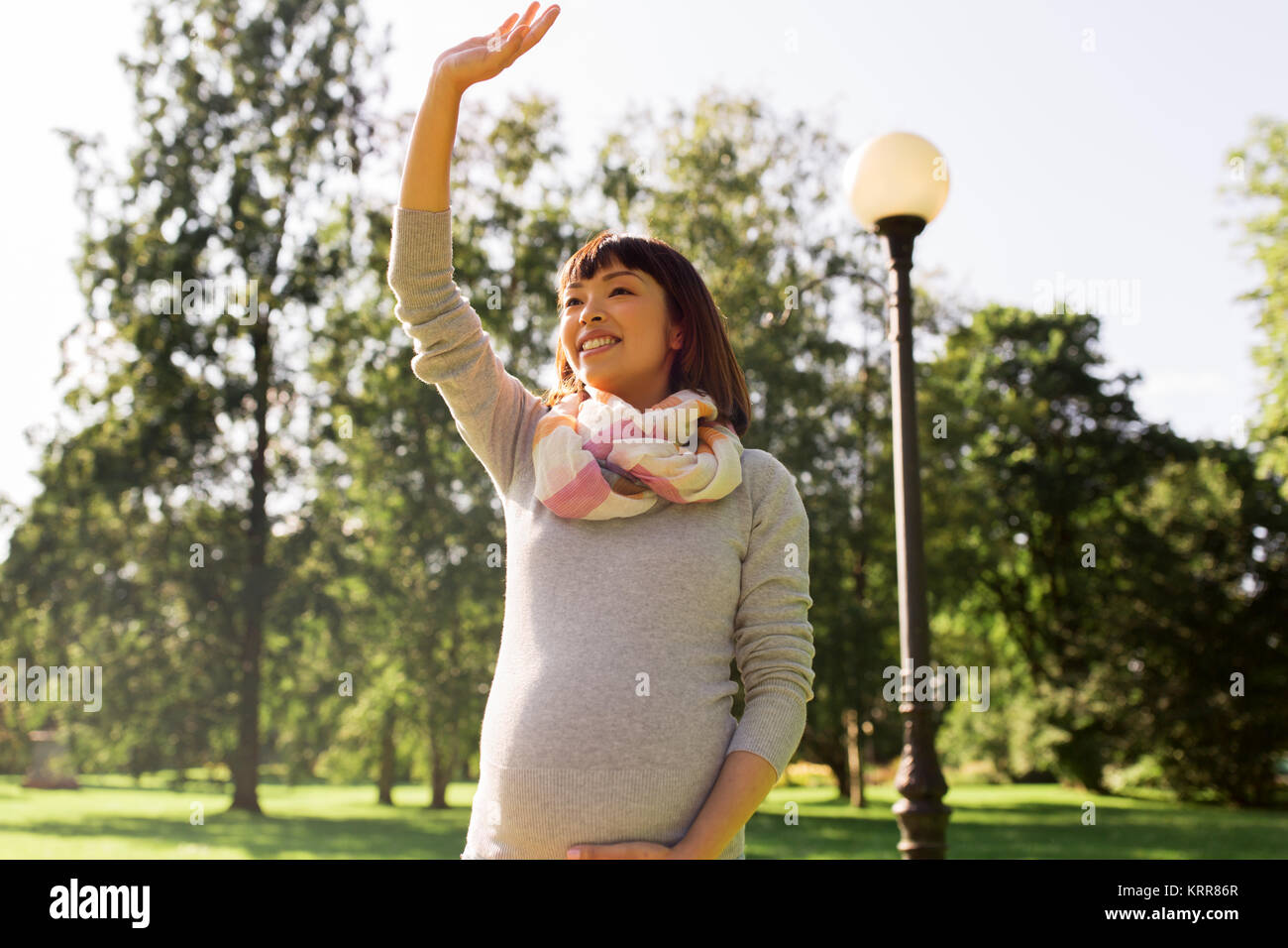 Woman pregnant belly touching waving hi-res stock photography and ...