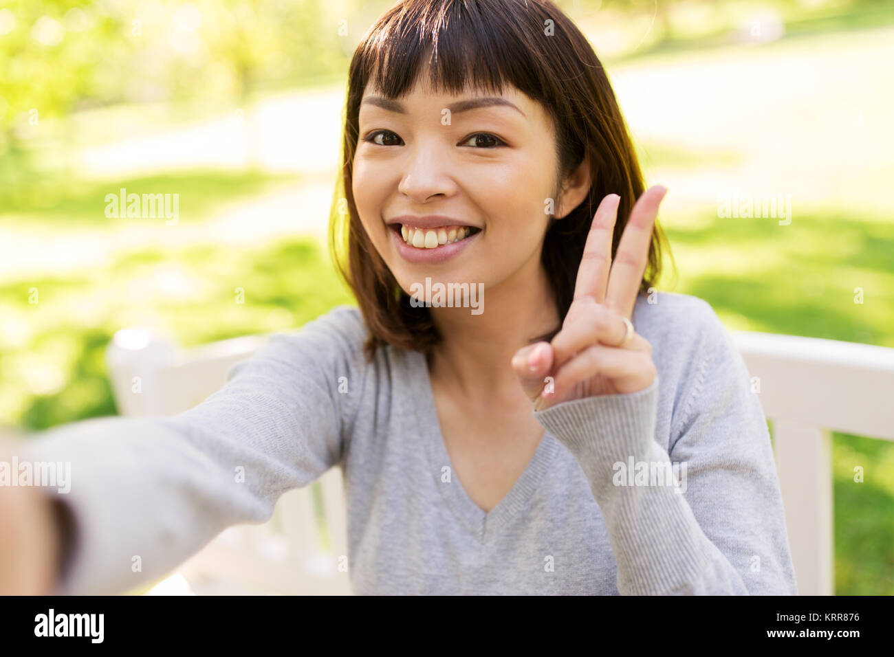 happy asian woman taking selfie and showing peace Stock Photo - Alamy