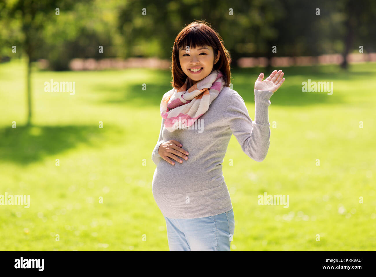 Woman pregnant belly touching waving hi-res stock photography and ...
