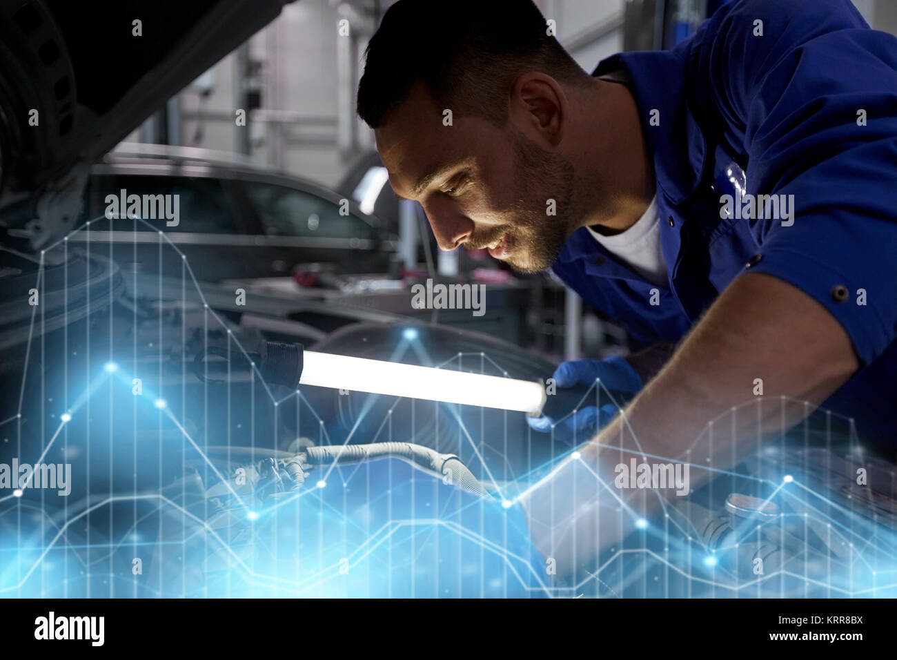 mechanic man with lamp repairing car at workshop Stock Photo - Alamy