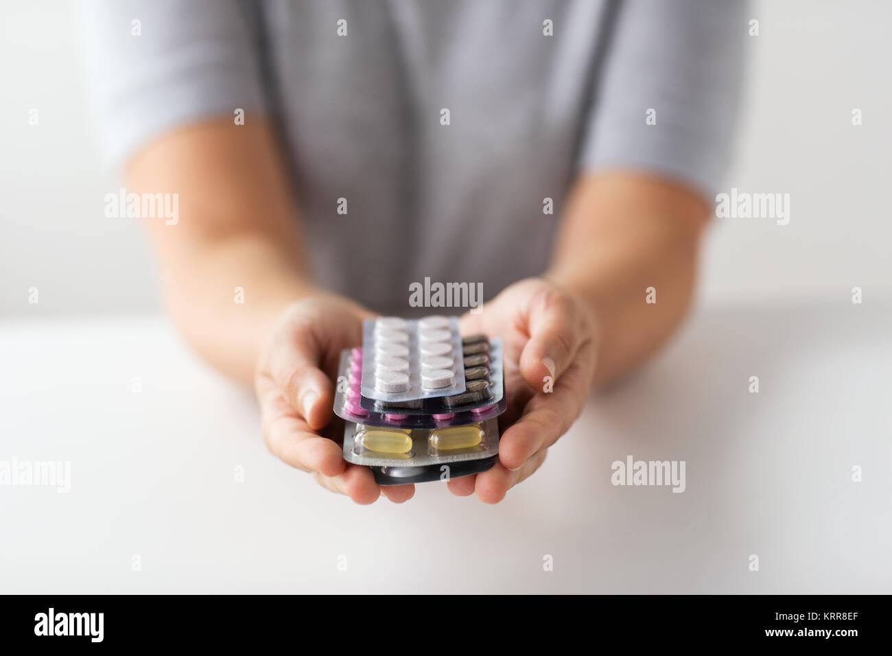 woman hands holding packs of pills Stock Photo - Alamy