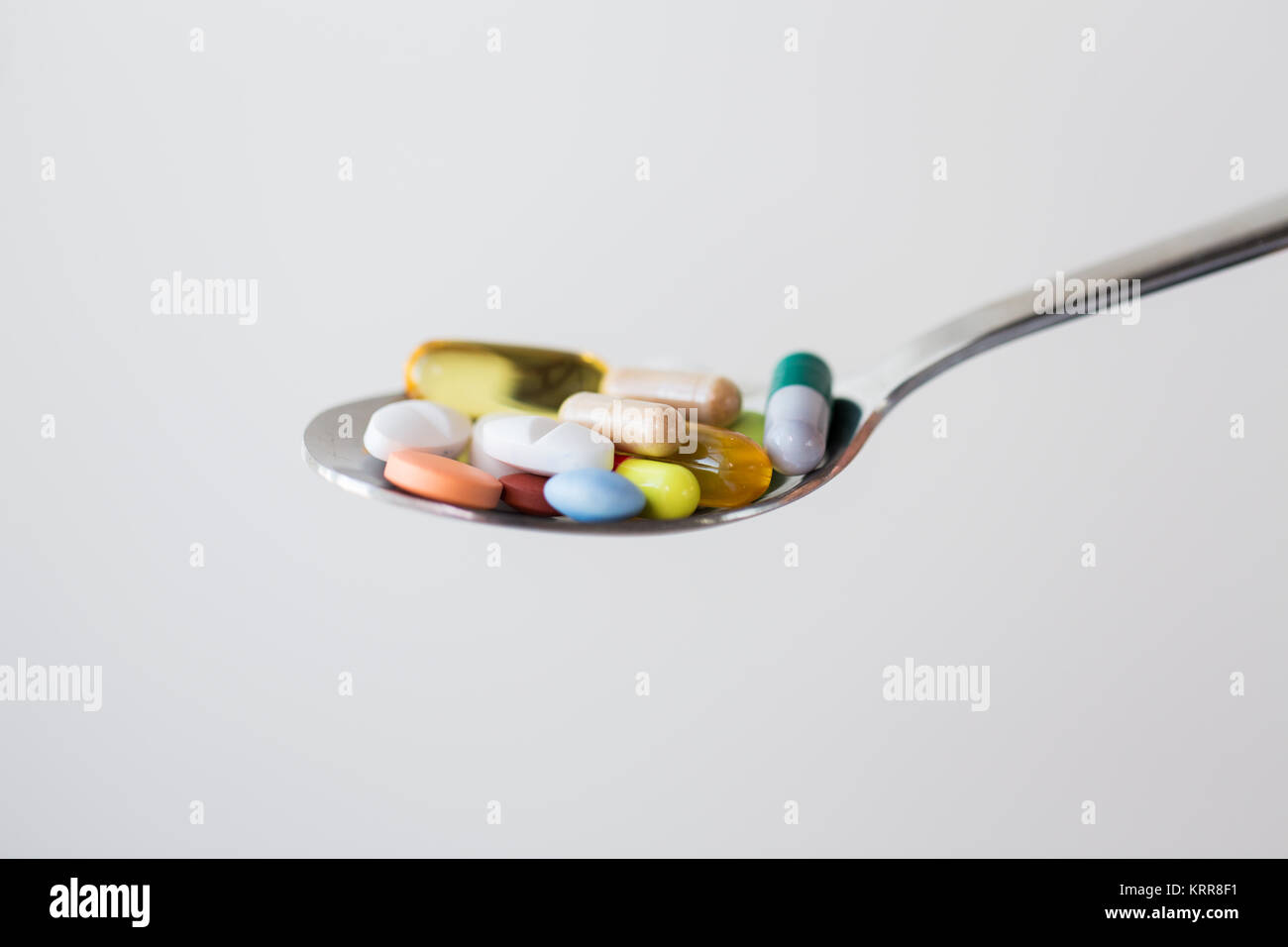 Healthcare drug capsules spoon hi-res stock photography and images - Alamy