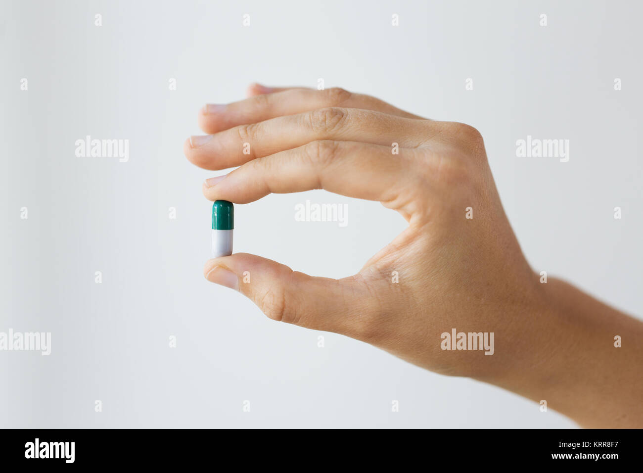 close up of hand holding capsule of medicine Stock Photo - Alamy