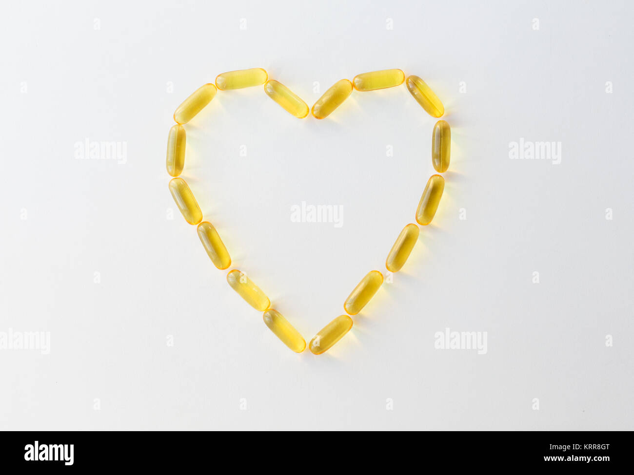 cod liver oil capsules in shape of heart Stock Photo - Alamy