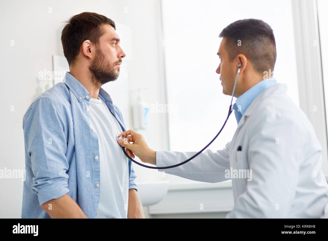doctor with stethoscope and patient at hospital Stock Photo - Alamy