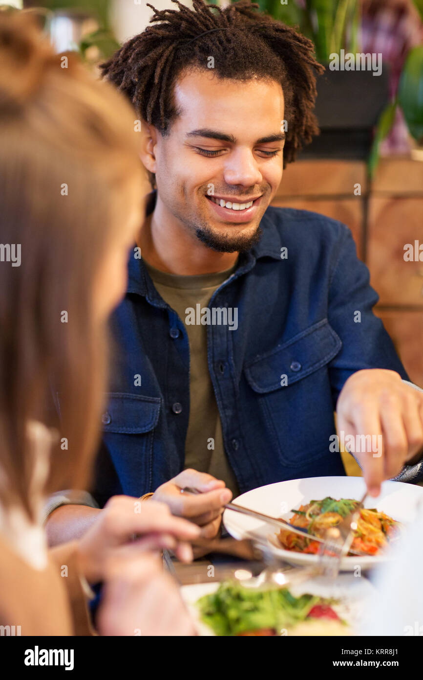 happy couple eating at restaurant Stock Photo - Alamy