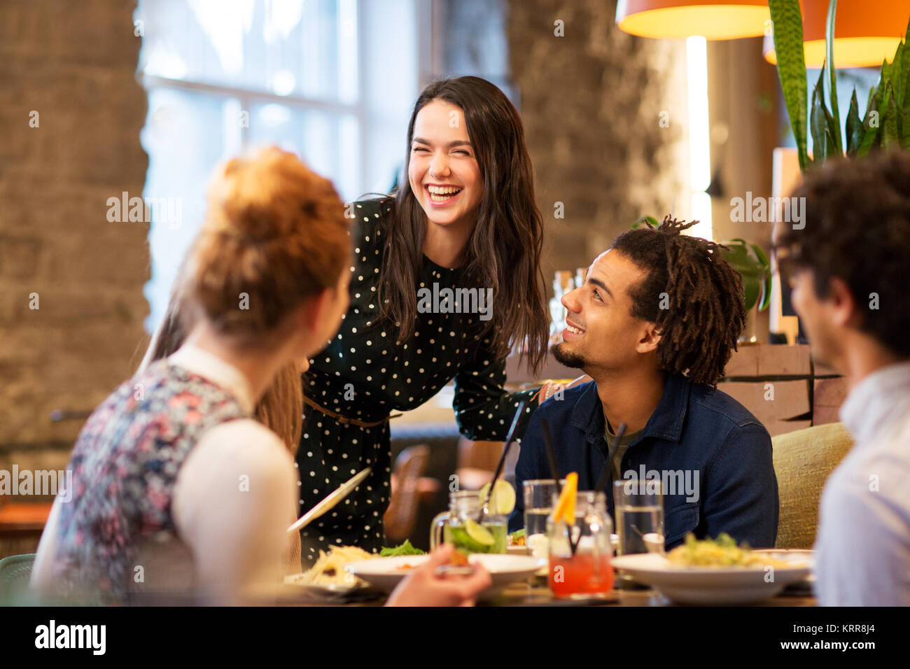 happy friends eating at restaurant Stock Photo - Alamy