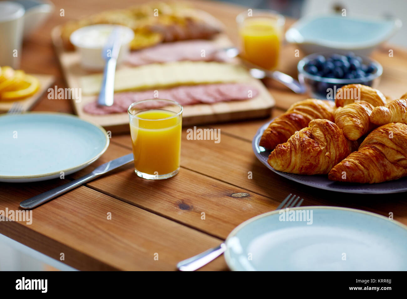 plate of croissants on wooden table at breakfast Stock Photo - Alamy