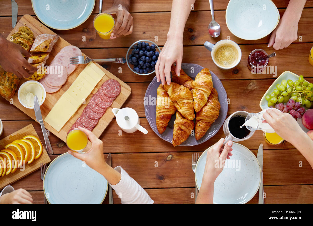 group of people having breakfast at table Stock Photo - Alamy