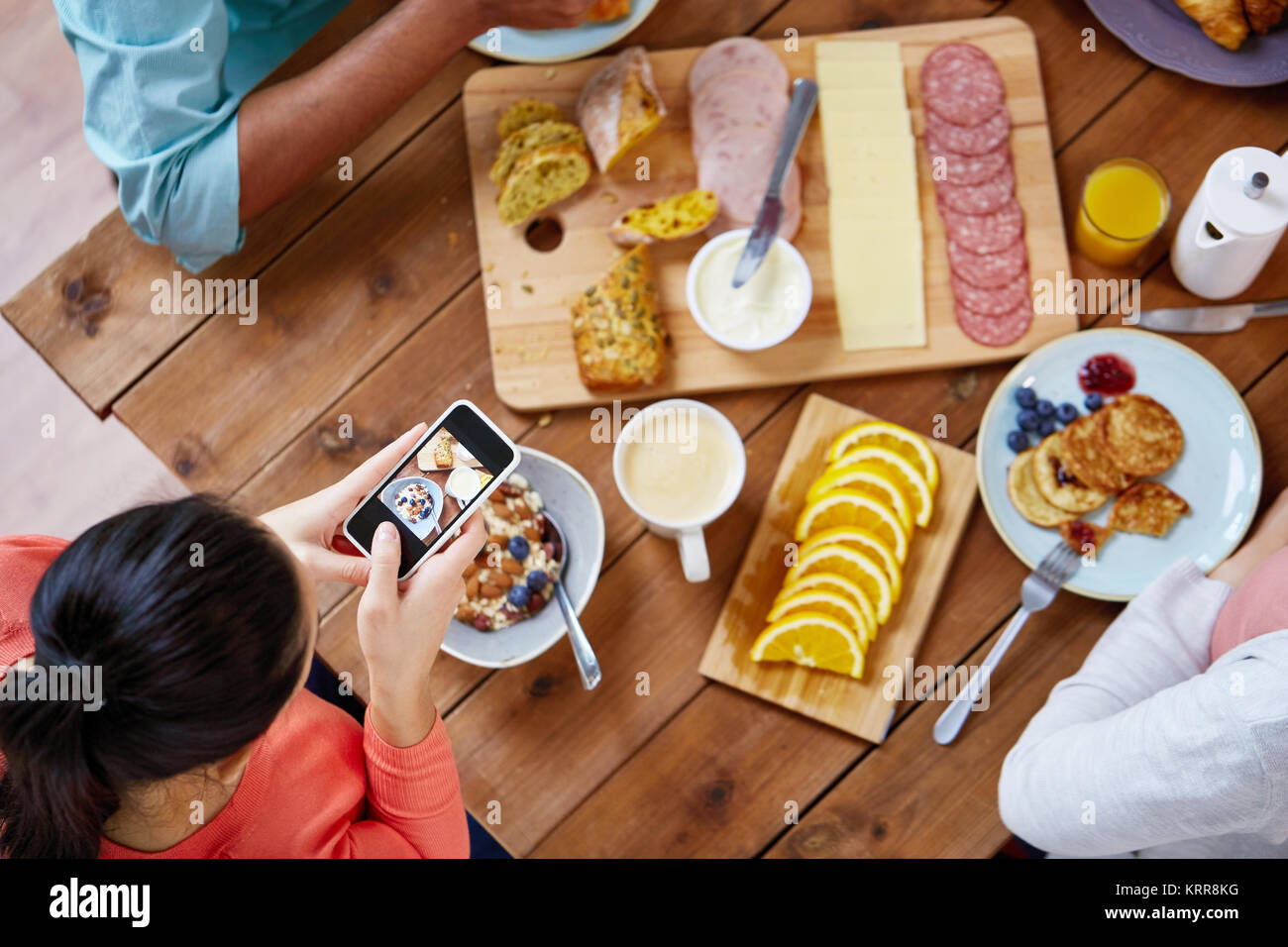 women with smartphones eating food at table Stock Photo - Alamy