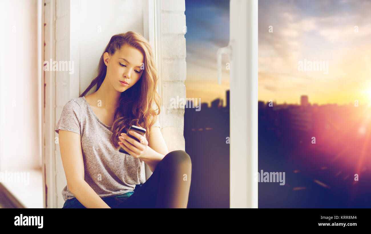 sad pretty teenage girl with smartphone texting Stock Photo - Alamy