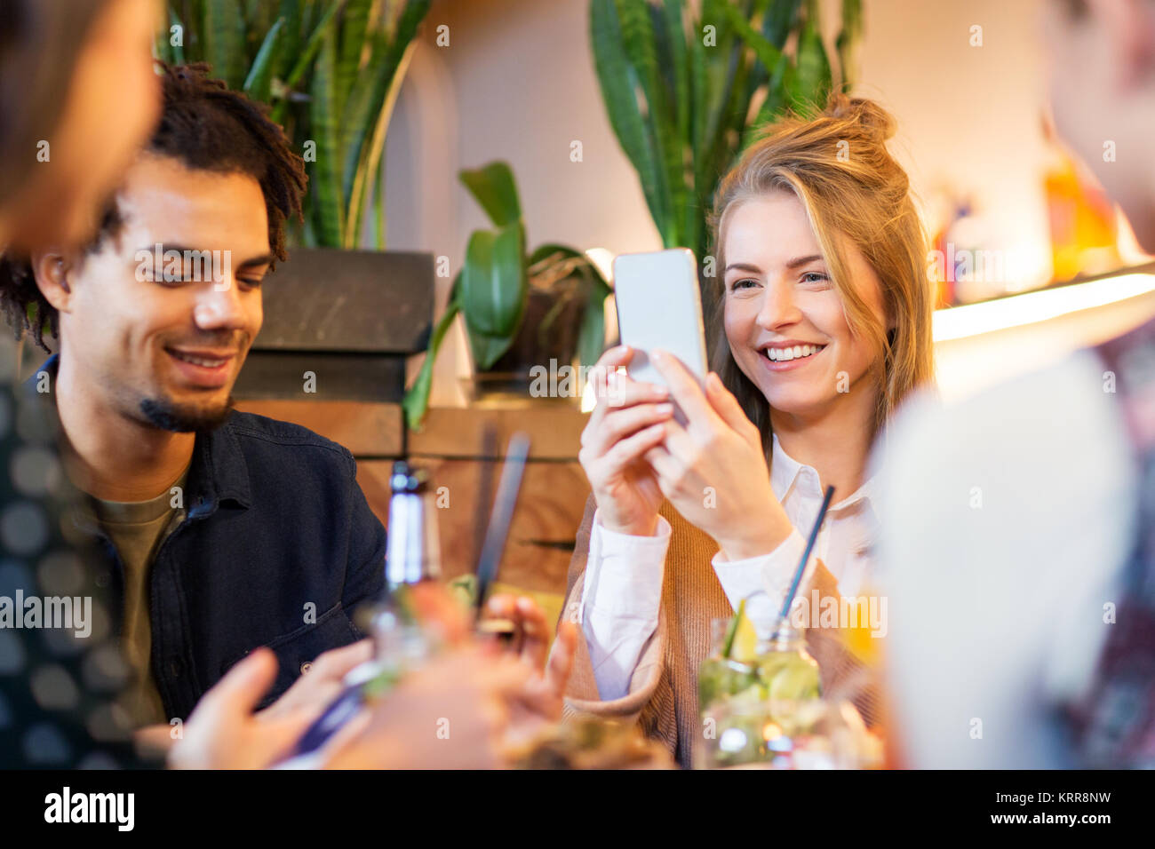 friends with smartphones eating at restaurant Stock Photo - Alamy