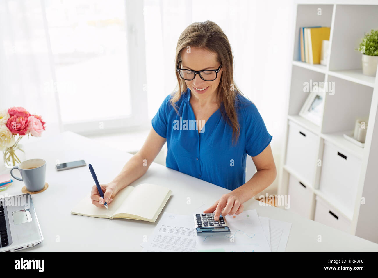 woman with calculator and notebook at office Stock Photo - Alamy