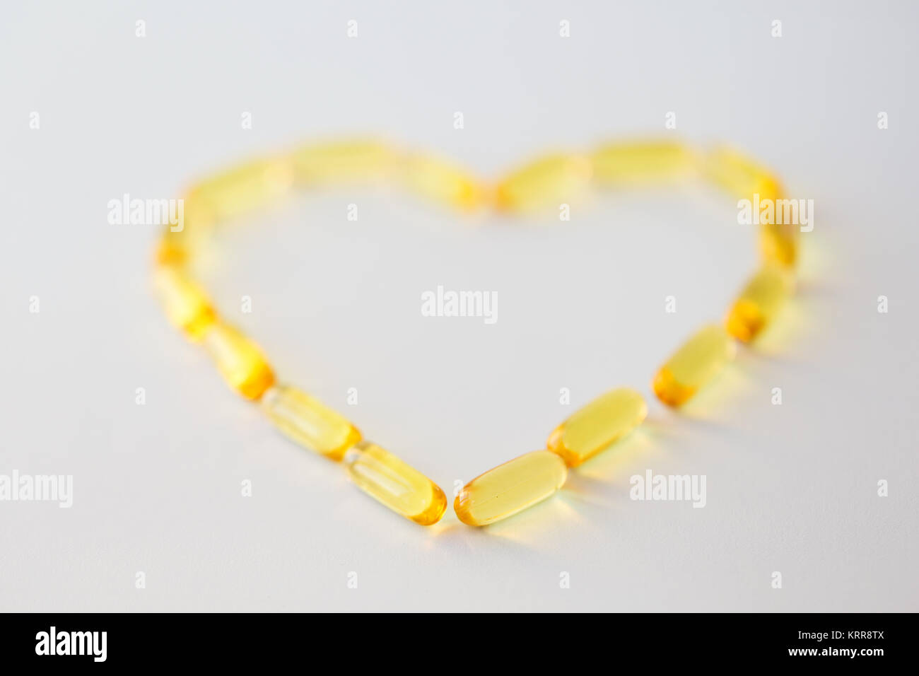 cod liver oil capsules in shape of heart Stock Photo - Alamy