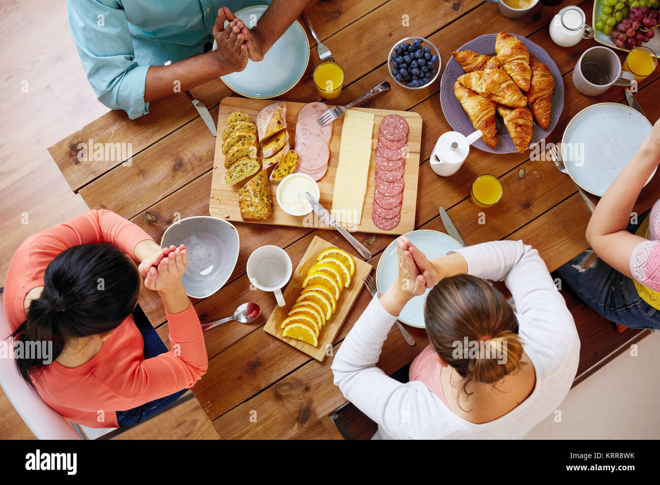 group of people at table praying before meal Stock Photo - Alamy