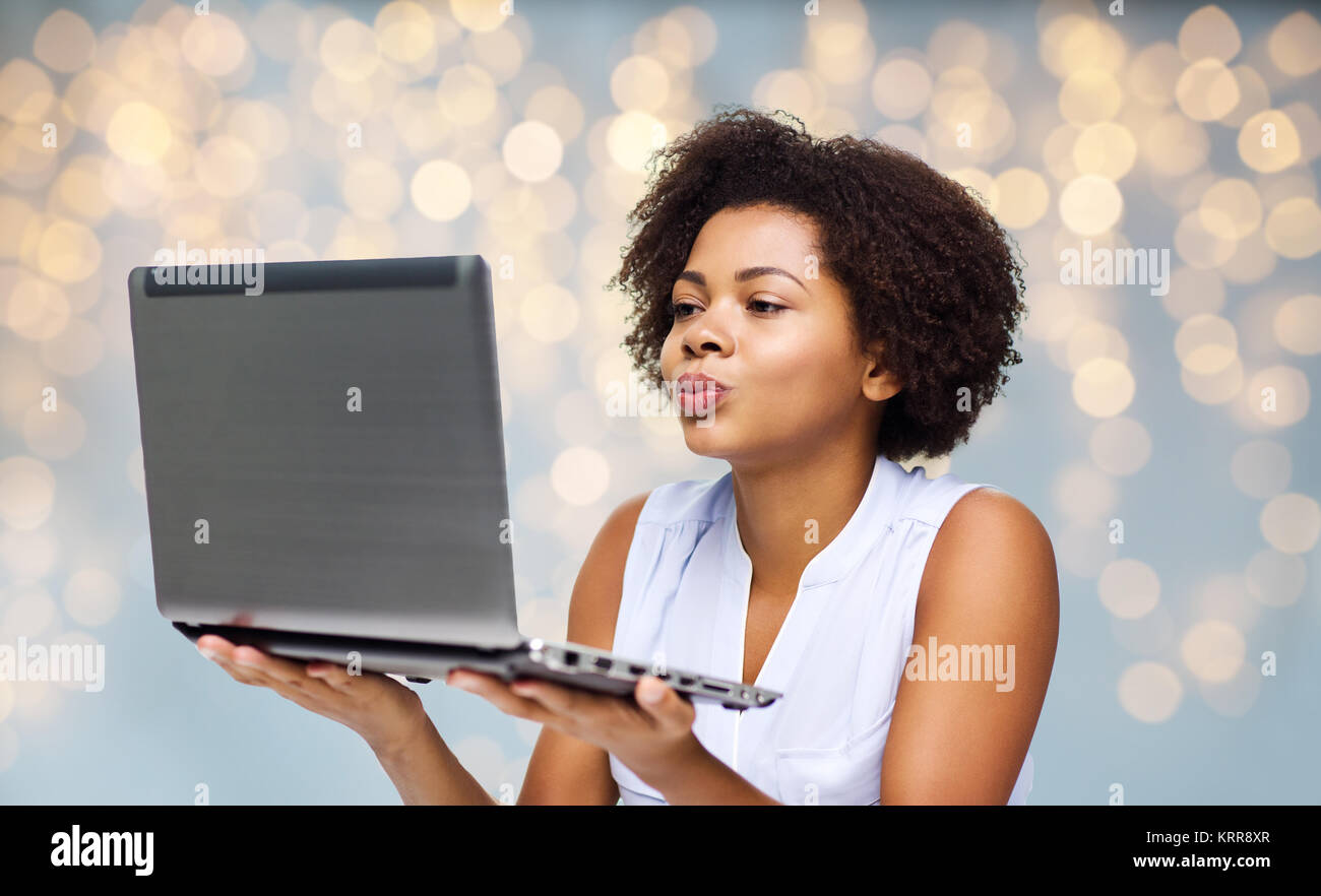 woman with laptop computer sending kiss to someone Stock Photo - Alamy
