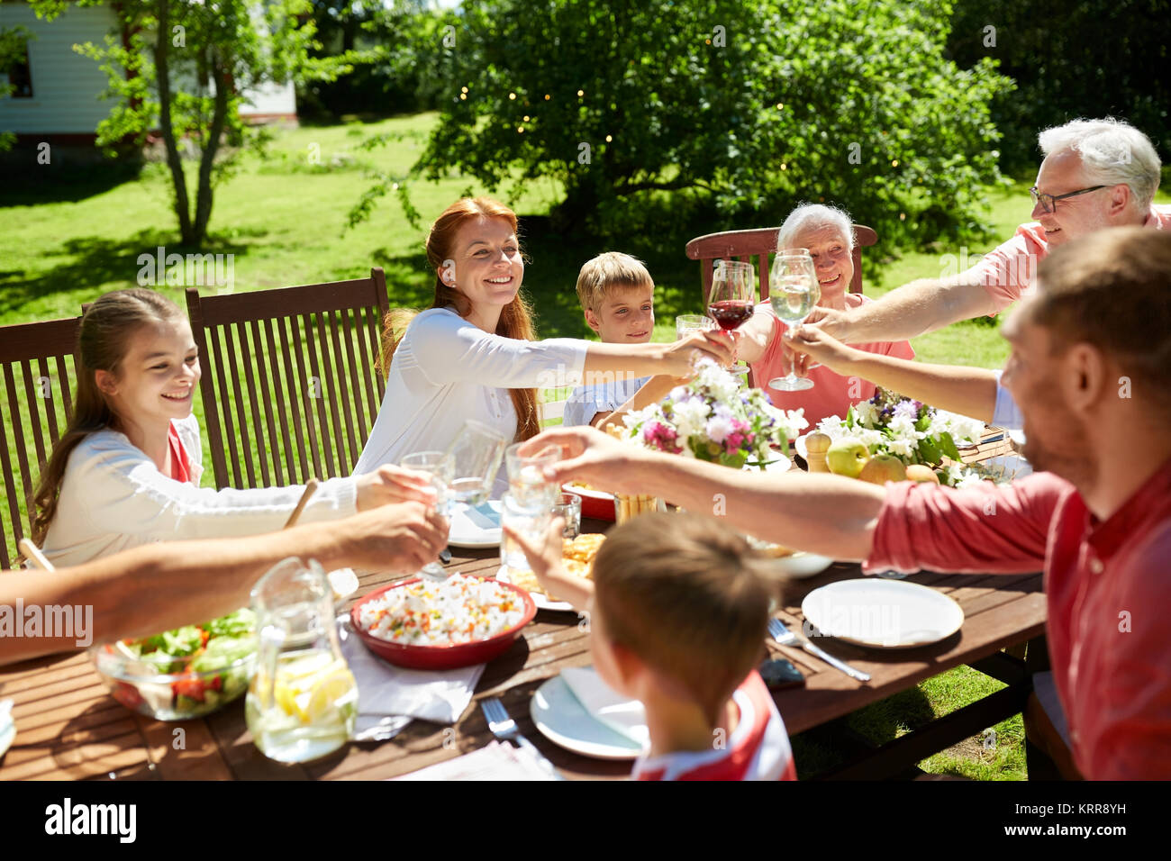 happy family having dinner or summer garden party Stock Photo - Alamy