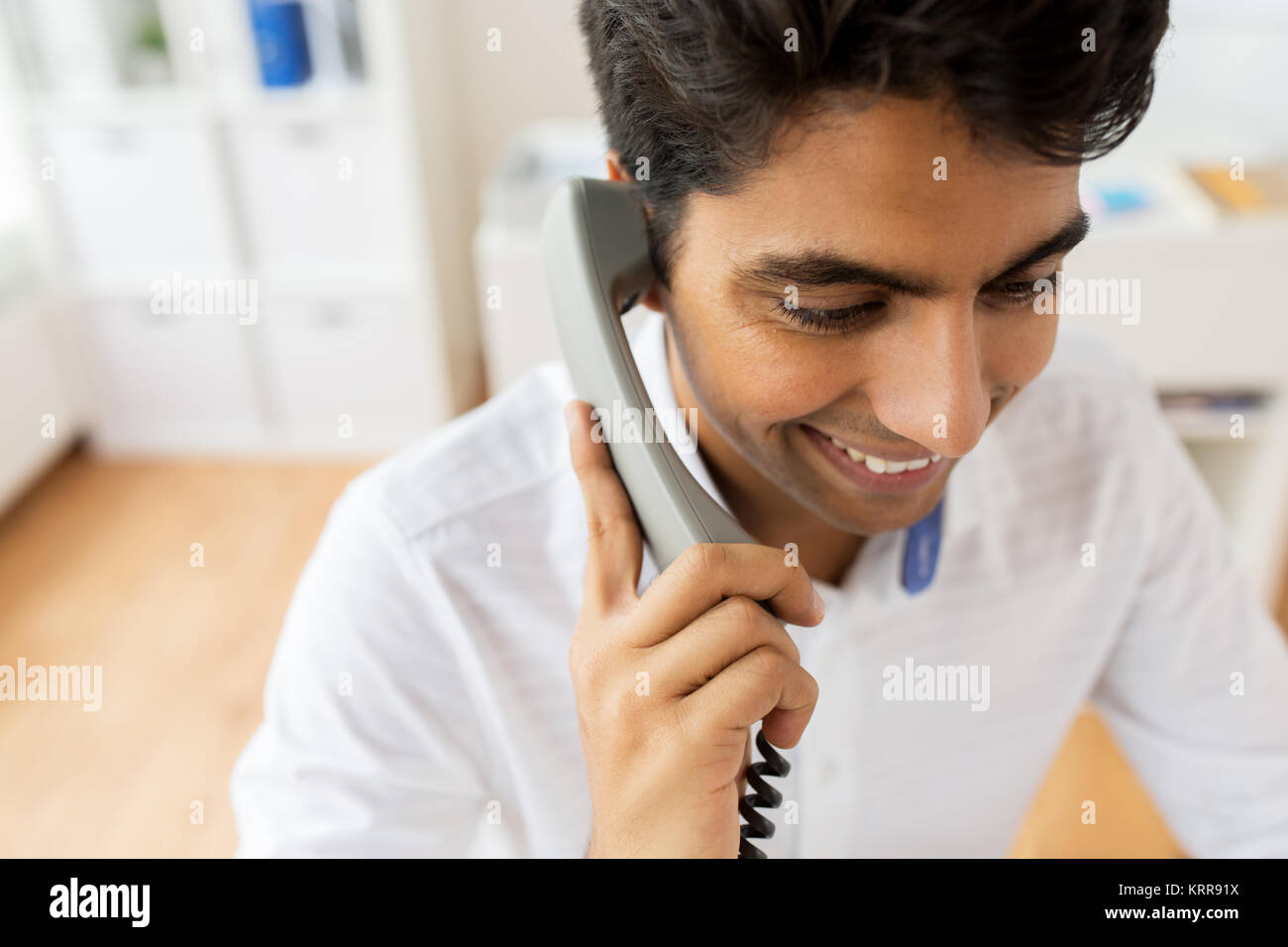 happy businessman calling on desk phone at office Stock Photo - Alamy