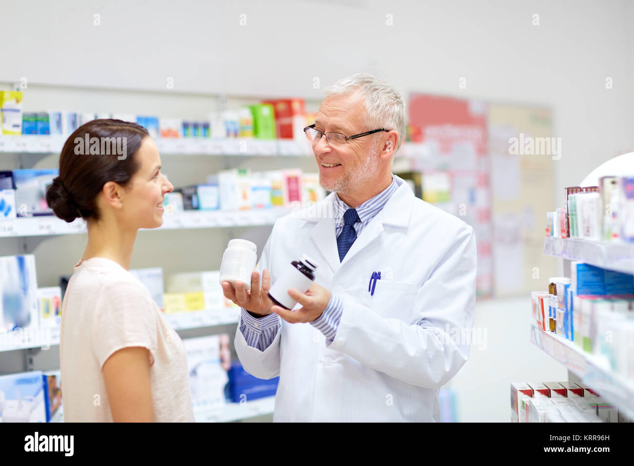 apothecary and woman with drug at pharmacy Stock Photo - Alamy
