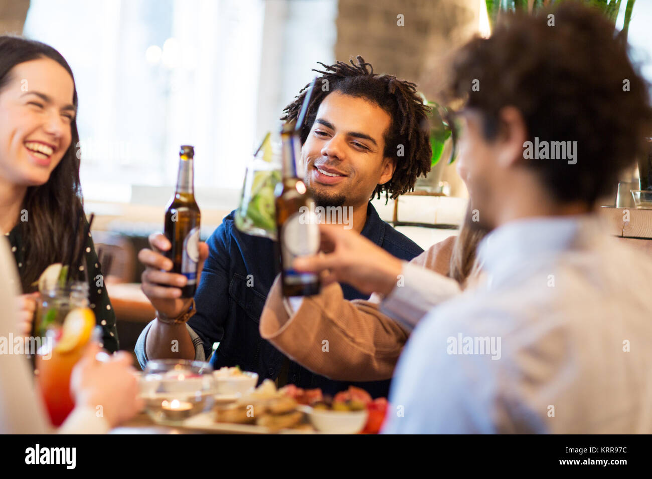 happy friends drinking non alcoholic beer at bar Stock Photo - Alamy