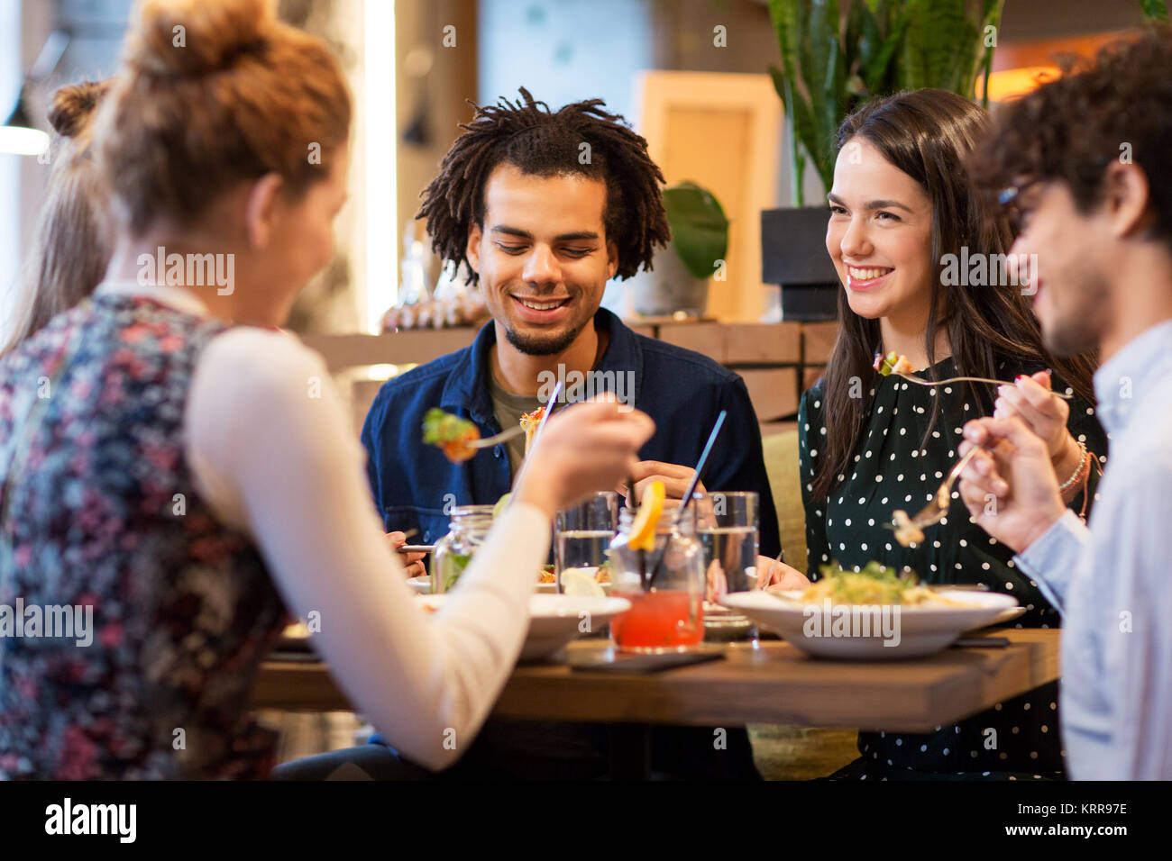 happy friends eating at restaurant Stock Photo - Alamy