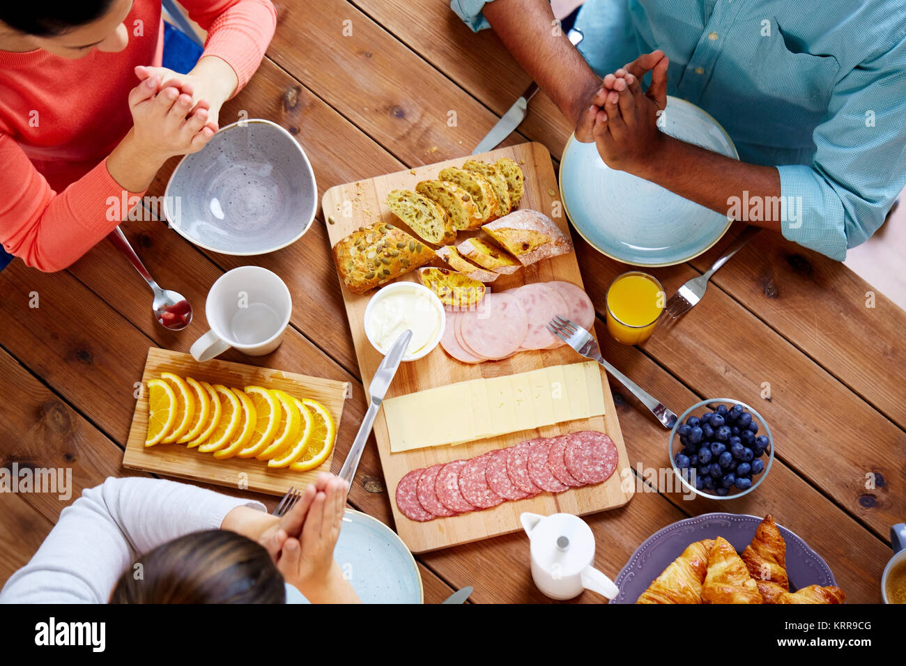 group of people at table praying before meal Stock Photo - Alamy