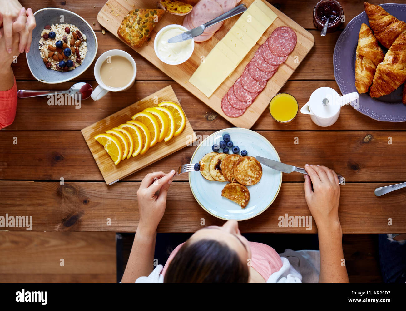woman with food on table eating pancakes Stock Photo - Alamy