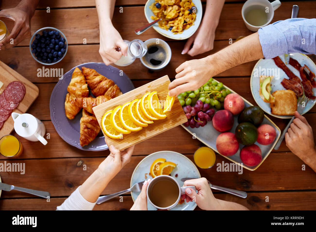 group of people having breakfast at table Stock Photo - Alamy