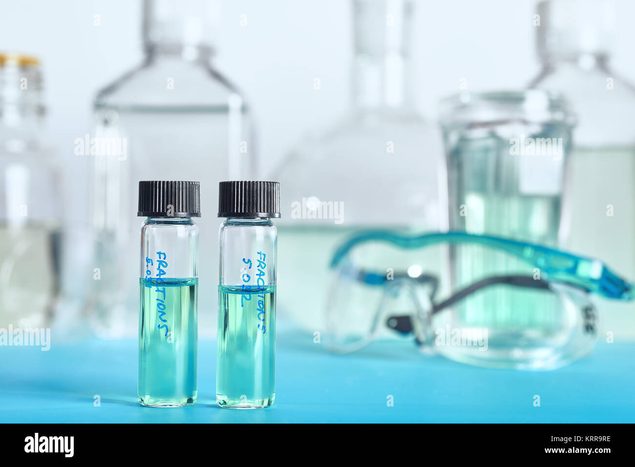 Two vials with liquid samples and histopathology tools and buffers as a ...