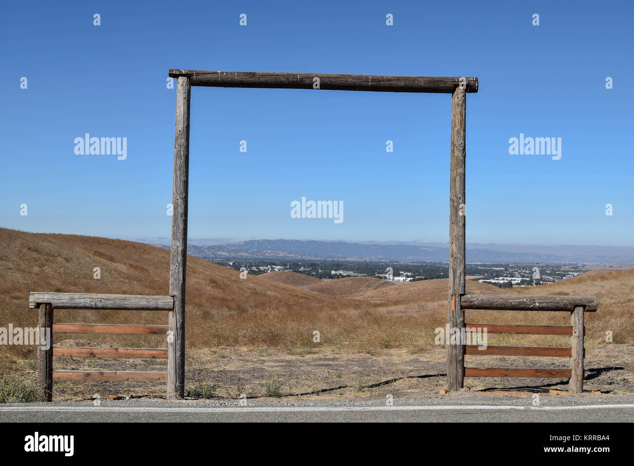 Old Wooden Framed Entrance to Farmland, with a blue sky and mountain ... Old Wooden Framed Entrance to Farmland, with a blue sky and mountain ...