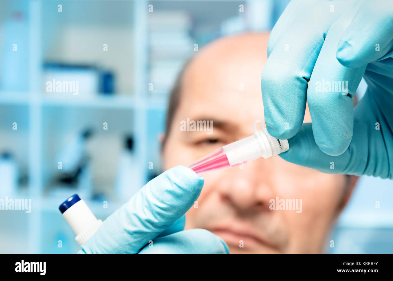 Scientist holds biological sample in disposable plastic tube Stock ...