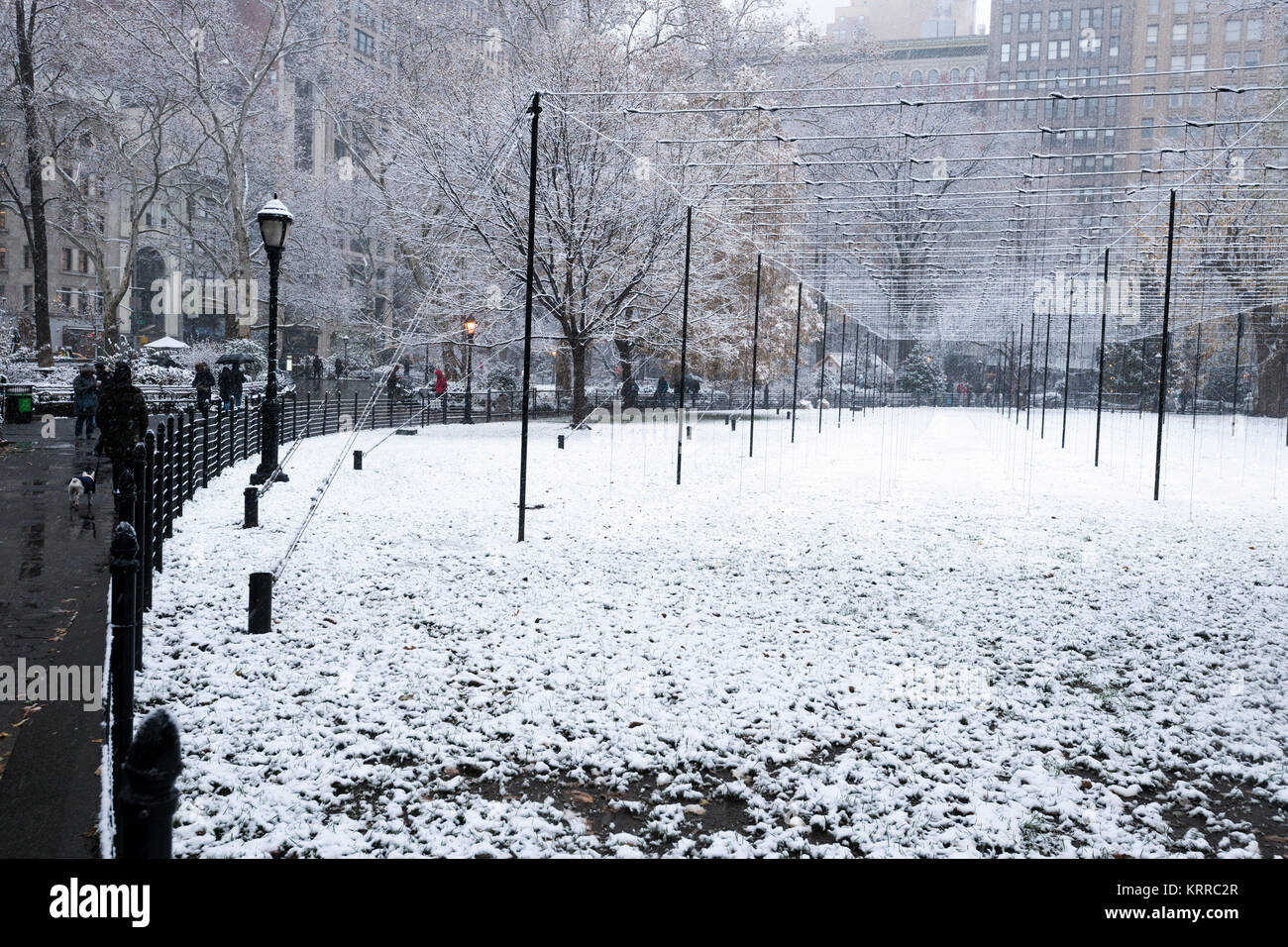 Visitors to Madison Square Park in New York enjoy the snow as they pass ...