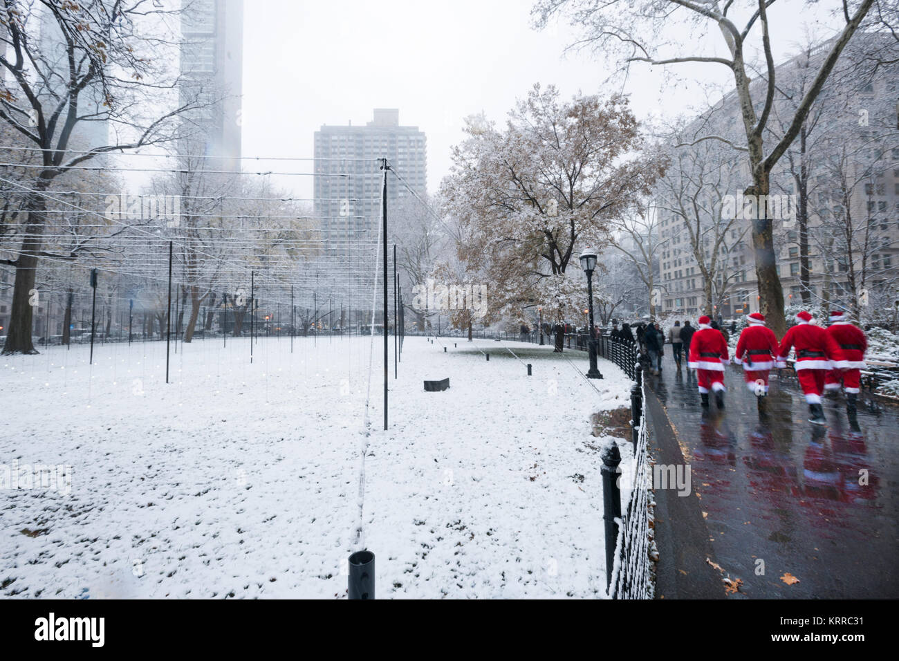 Visitors to Madison Square Park in New York enjoy the snow as they pass ...