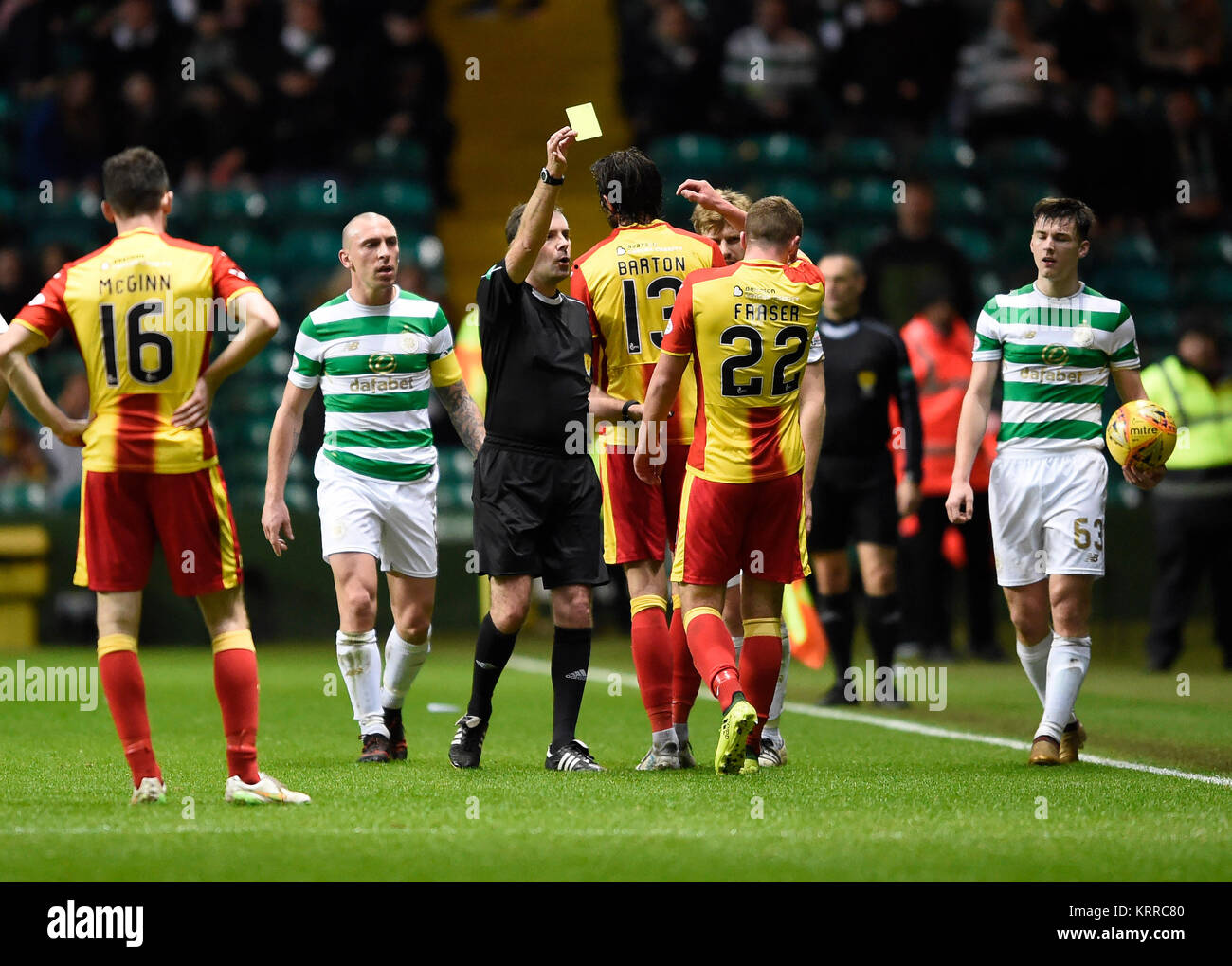 Referee Alan Muir shows Partick's Gary Fraser a yellow card for kicking ...