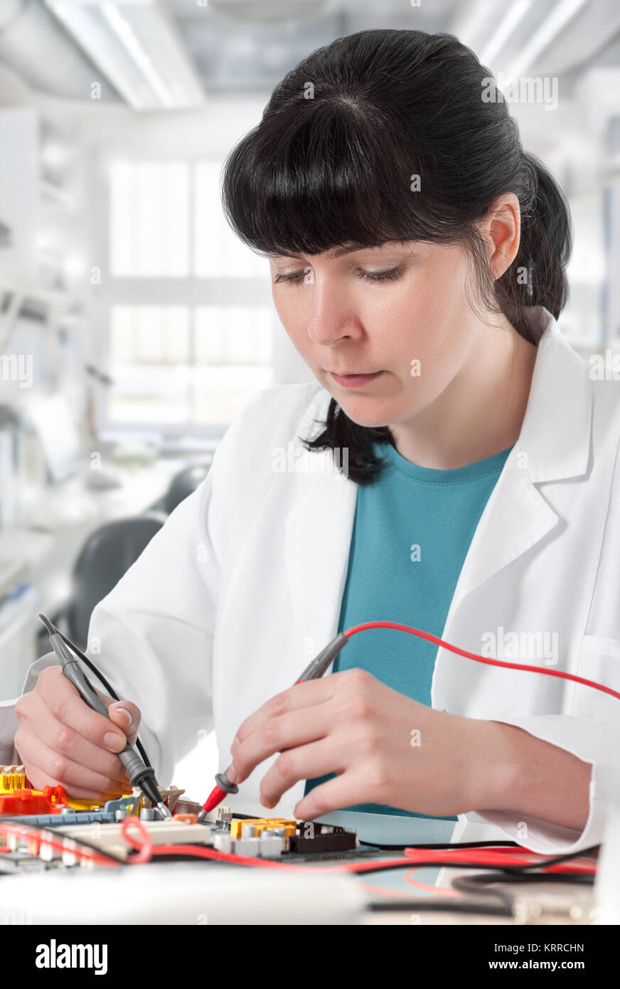 Tech repairs electronic device in modern laboratory Stock Photo - Alamy