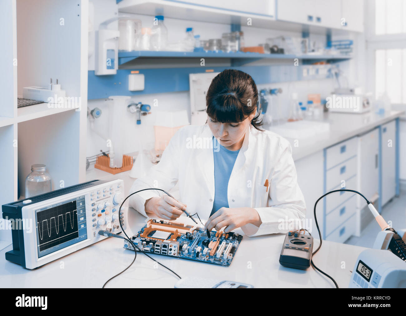 Young scientist repairs electronic device in modern laboratory Stock ...