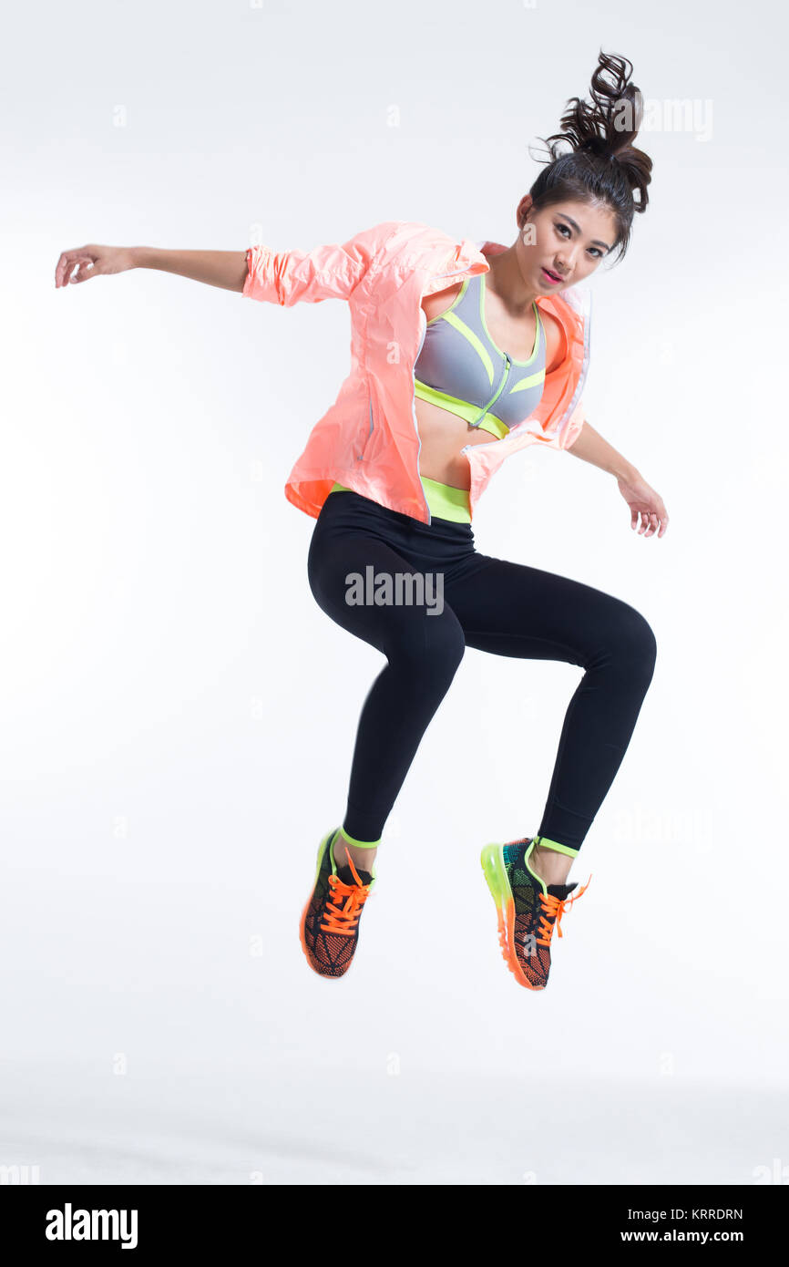 Young female athlete jumping Stock Photo - Alamy