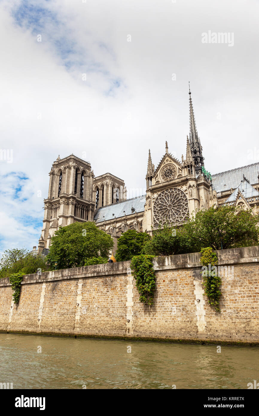 A side view of Notre Dame Cathedral in Paris with the River Seine in ...