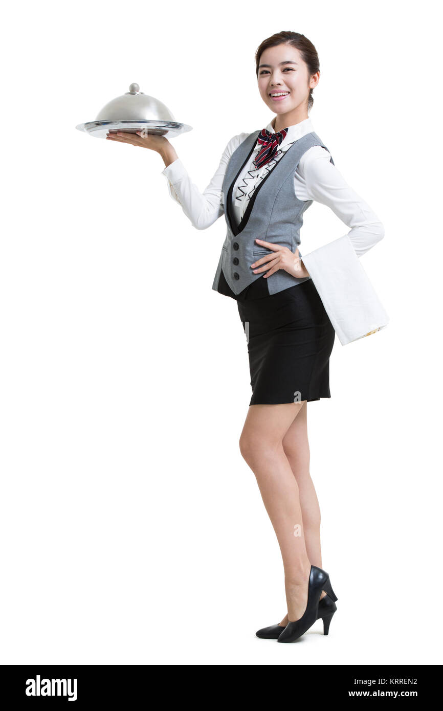 Smiling waitress in hotel with serving tray Stock Photo - Alamy