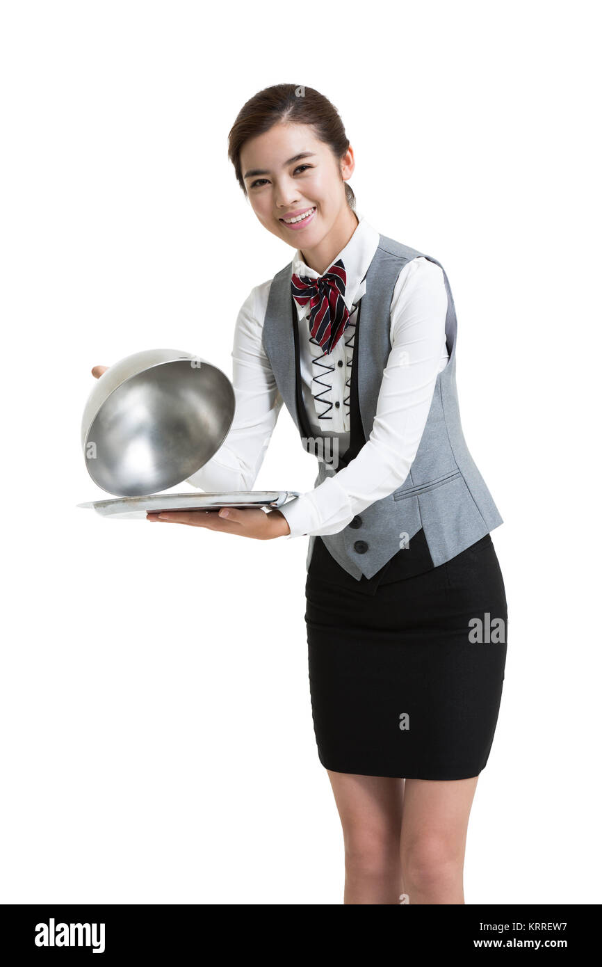 Smiling waitress in hotel with serving tray Stock Photo - Alamy
