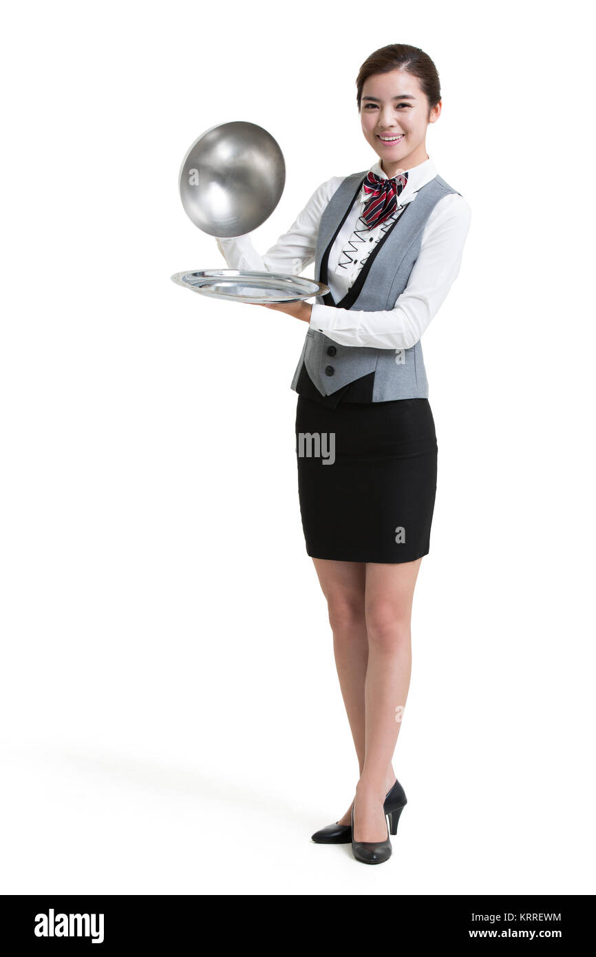 Smiling waitress in hotel with serving tray Stock Photo - Alamy