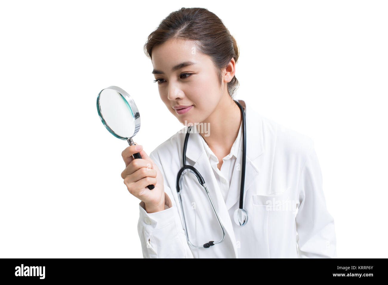 Young female doctor using magnifying glass Stock Photo - Alamy