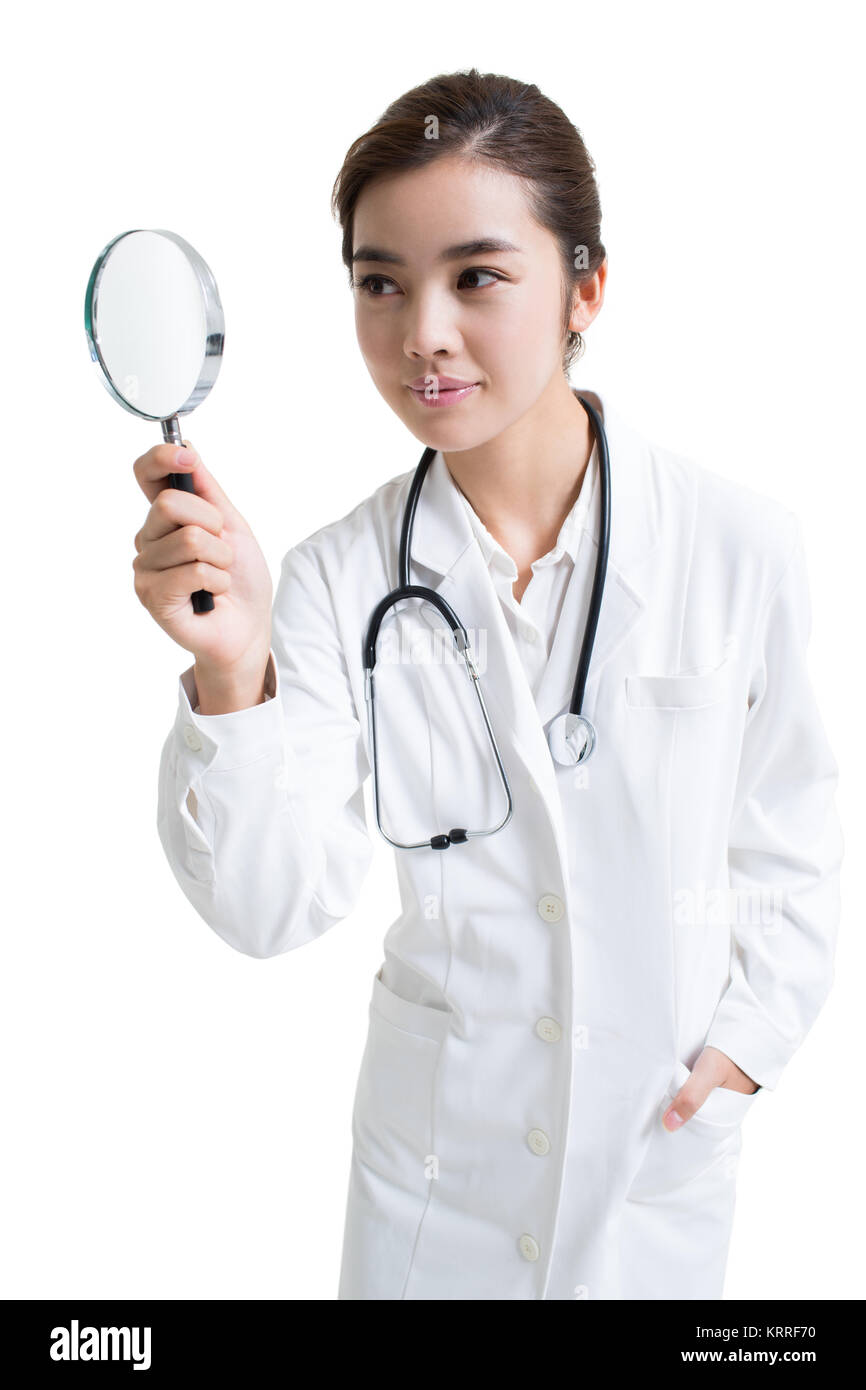 Young female doctor using magnifying glass Stock Photo - Alamy