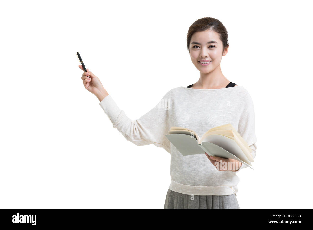 Young female teacher teaching with textbook Stock Photo - Alamy