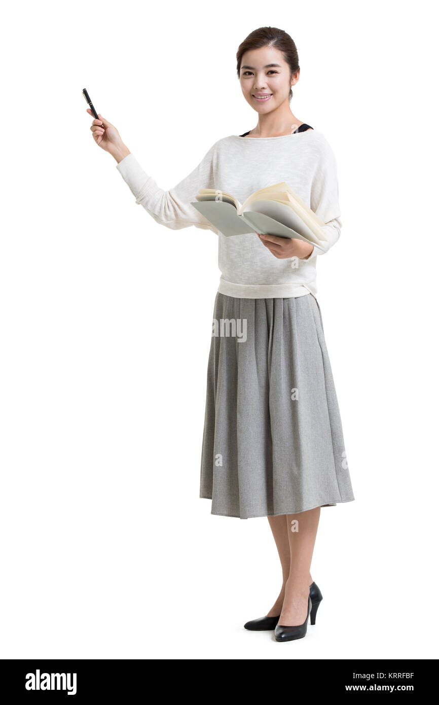 Young female teacher teaching with textbook Stock Photo - Alamy